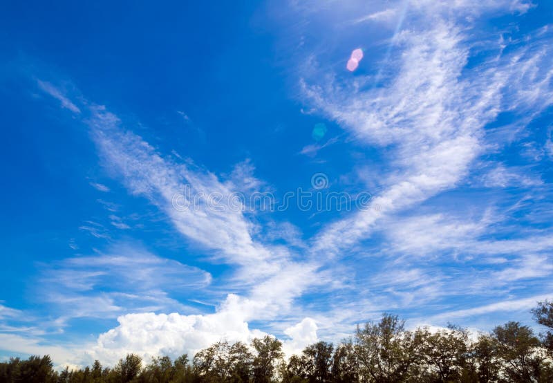 White Fluffy Clouds in Blue Sky with Light from the Sun Over the Stock ...