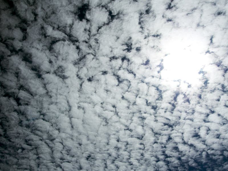 White Fluffy Clouds in the Bright Blue Sky with Light from the S Stock ...