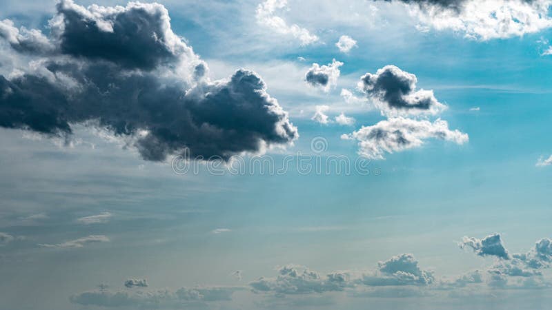 White Fluffy Clouds Slowly Float through the Blue Daytime Sky Timelapse ...