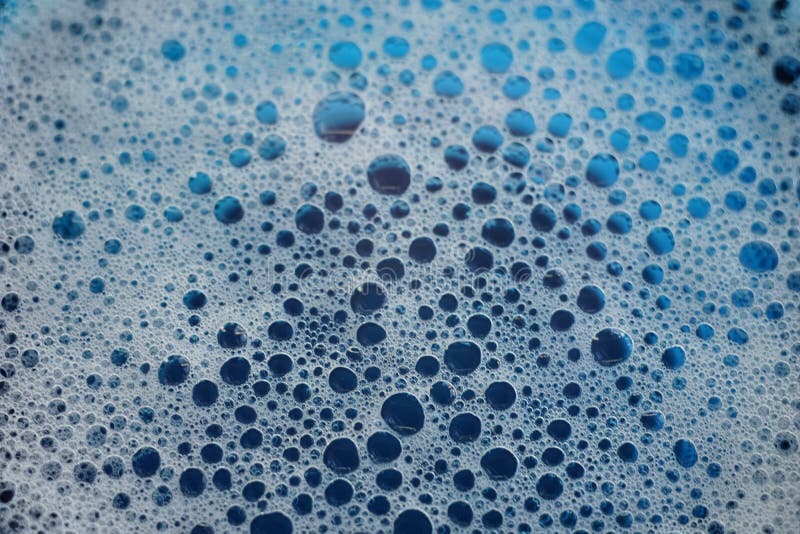 White Foam with Bubbles Popping in Deep Blue Water Stock Photo - Image ...