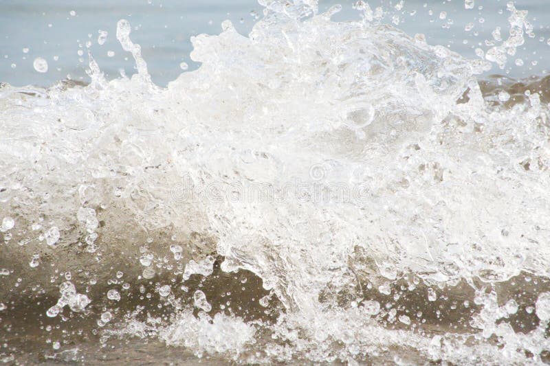 White Foam and Sea Water Drop Splashes Slow Motion with Sand and Blue ...