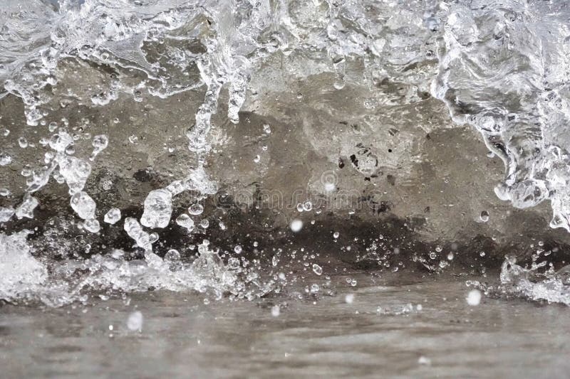 White Foam and Sea Water Drop Splashes Slow Motion with Sand and Blue ...