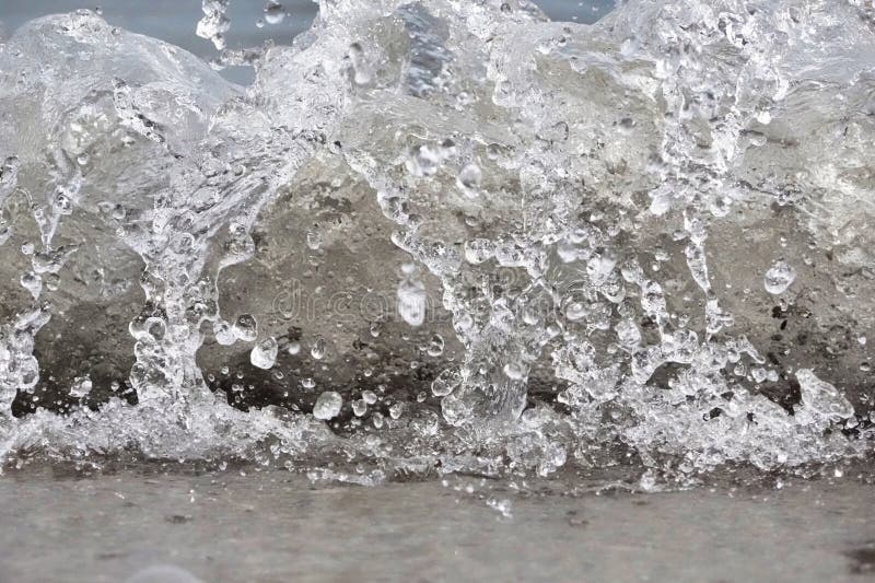 White Foam and Sea Water Drop Splashes Slow Motion with Sand and Blue ...