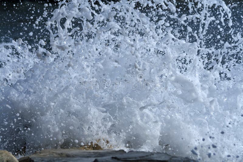 Sea wave splash on rocks stock photo. Image of white - 170754208
