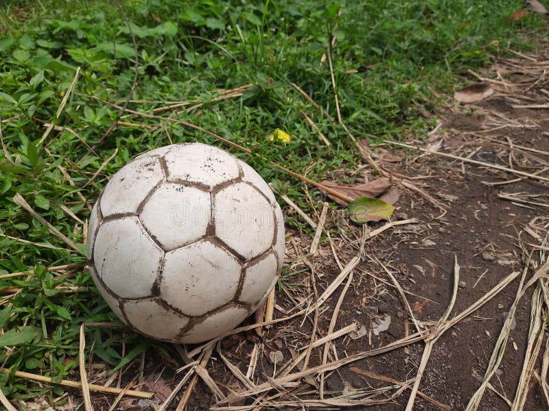 A White Football between Grass Field and Soil Stock Photo - Image of ...