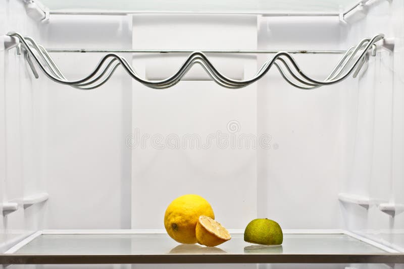 White Fridge almost Empty with a Lime and Lemon and a Half Stock Photo ...
