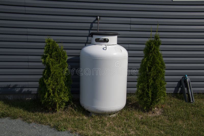 A White Fuel Tank Next To a House Stock Photo - Image of grey, summer ...