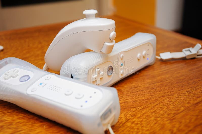 White Gaming Controllers on Wooden Table Ready for Fun Stock Photo ...