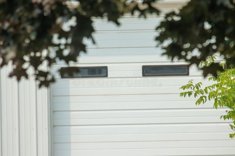 A Garage Door with Two Windows in a Steel Building Stock Photo - Image ...