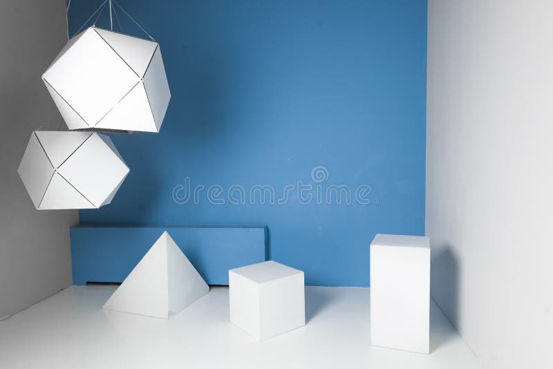 White Geometric Shapes in Room with Blue Wall Stock Photo - Image of ...