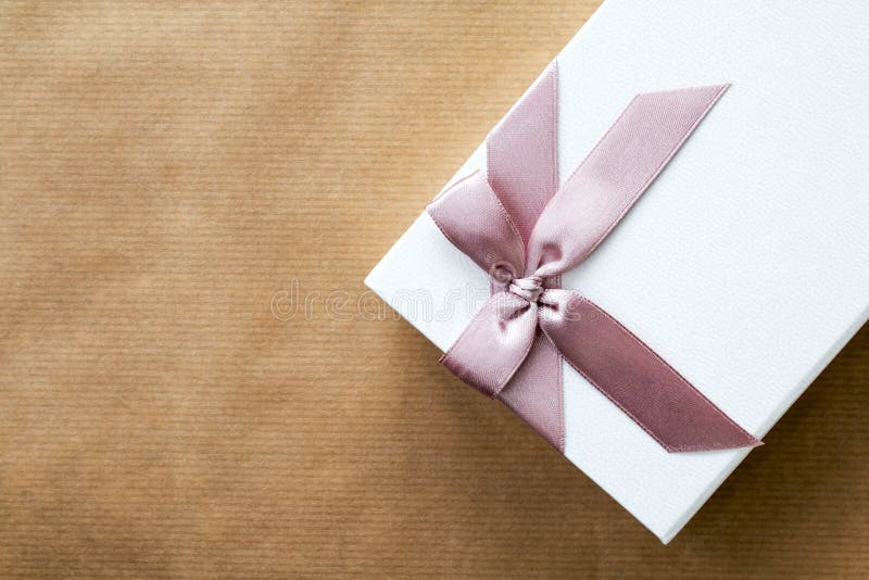 White Gift Box With Pink Bow On Brown Paper Stock Photo - Image of ...