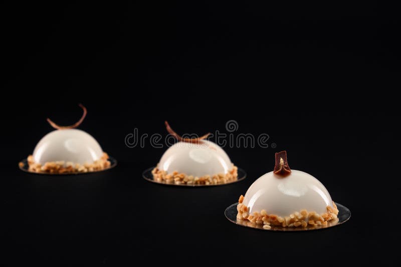 White Glazed Half Sphere Cakes Isolated on Black. Stock Photo - Image ...