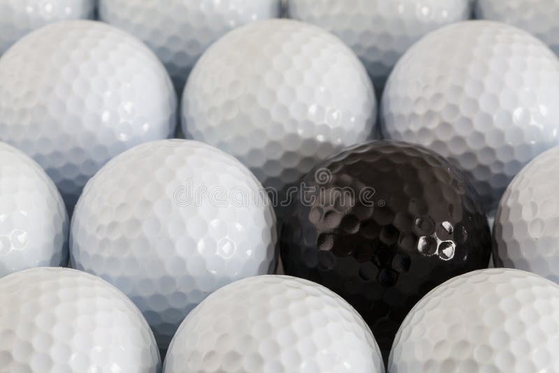 White Golf Balls and One Black Ball Stock Photo - Image of competition ...