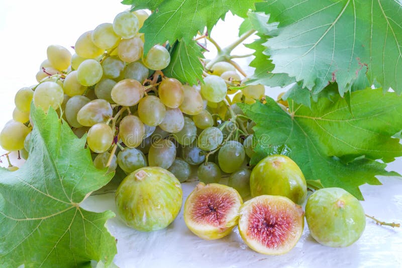 Seasonal Fruits White Grapes and Figs Arranged on a White Surface with ...