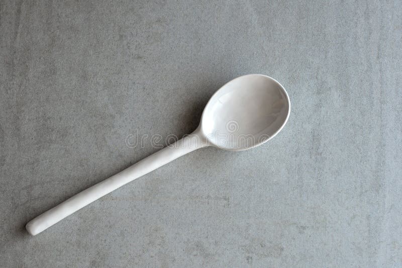 White and Gray Spoon Ceramic on a Gray Background Stock Image - Image ...