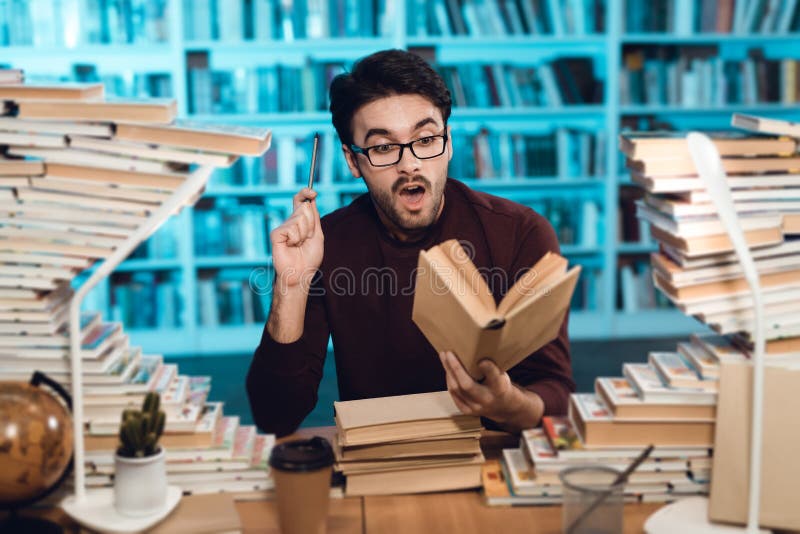 White Guy Surrounded by Books in Library. Student is Emotionally ...