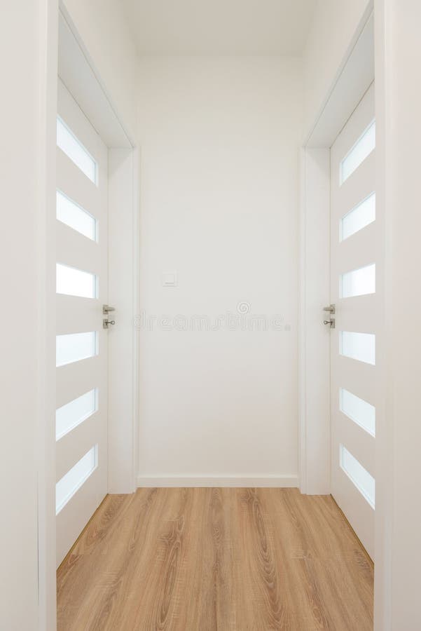 White hallway with doors stock photo. Image of entrance - 153863326