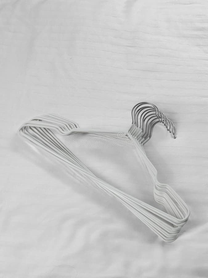 A White Hanger is Casually Resting on a Pristine White Cloth Stock ...