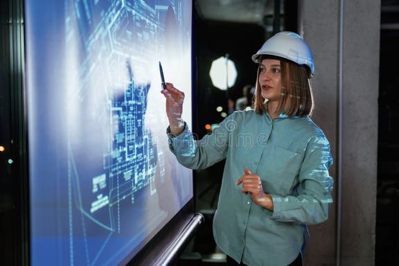 In White Hard Hat. Female Architect is Showing Construction Site Plan ...