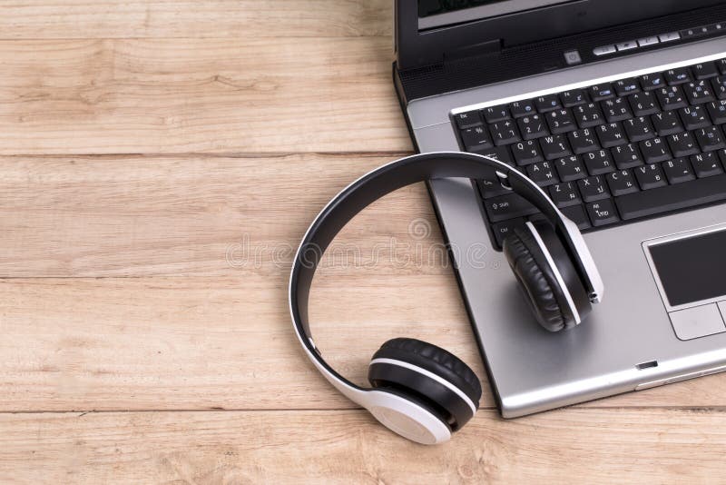 White Headphones Placed on a Computer Laptop on the Table Stock Image ...