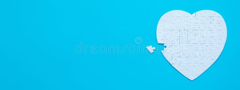 White Heart Shape of Jigsaw Puzzle Pieces on Blue Background. Concepts ...
