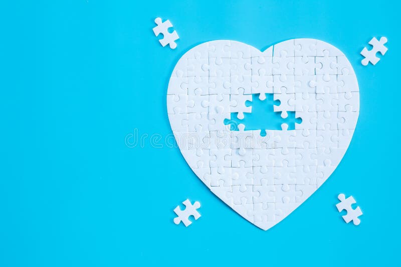 White Heart Shape of Jigsaw Puzzle Pieces on Blue Background. Concepts ...