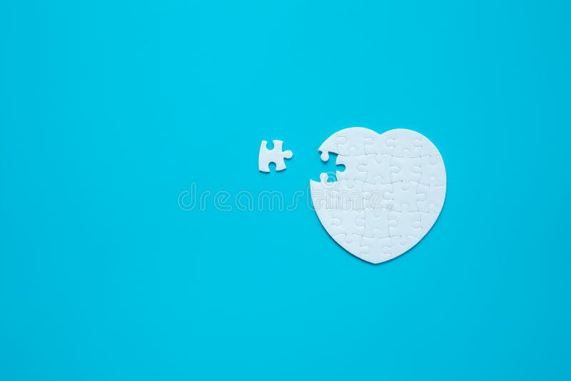 White Heart Shape of Jigsaw Puzzle Pieces on Blue Background. Concepts ...