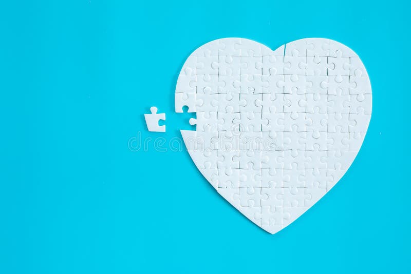 White Heart Shape of Jigsaw Puzzle Pieces on Blue Background. Concepts ...