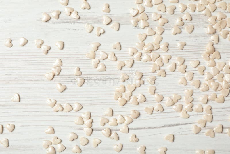 White Heart Shaped Sprinkles on Light Wooden Table, Flat Lay Stock ...
