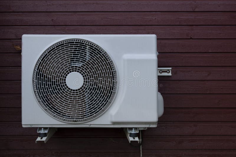 A White Heat Pump Unit Mounted on a Red Wood Panel Stock Image - Image ...