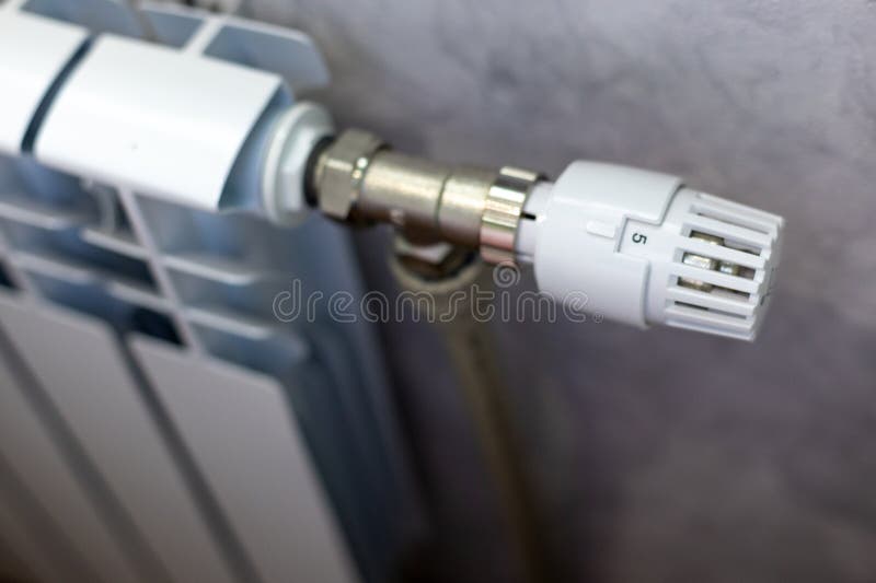 White Heater with Radiator and a Modern Thermostat on the Wall in an ...