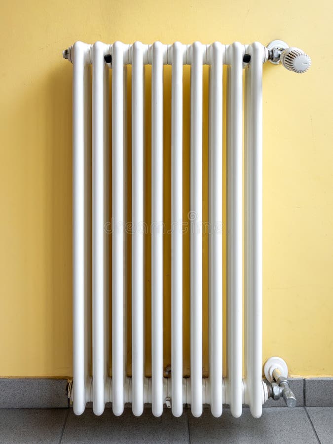 White Heating Radiator on Yellow Wall Stock Photo - Image of pipe ...