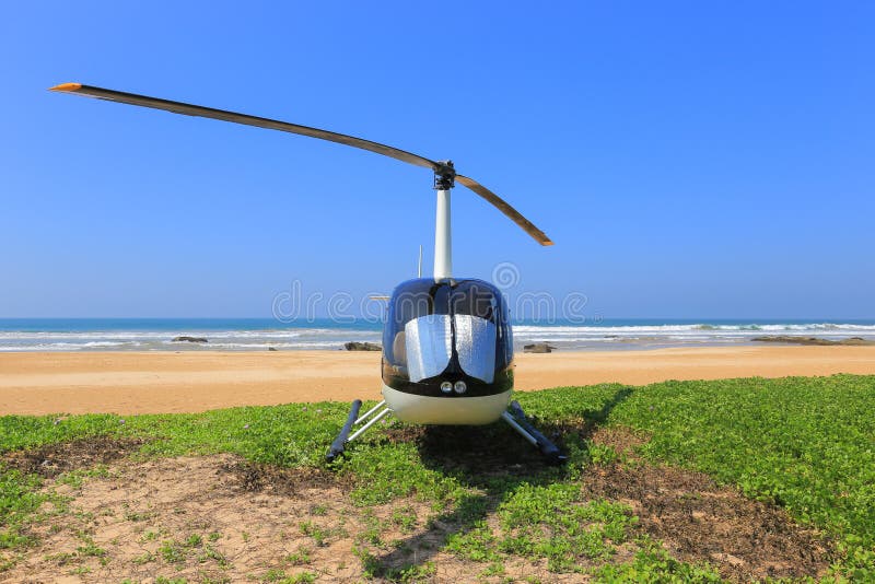 Helicopter on the beach stock image. Image of aviation - 156179243