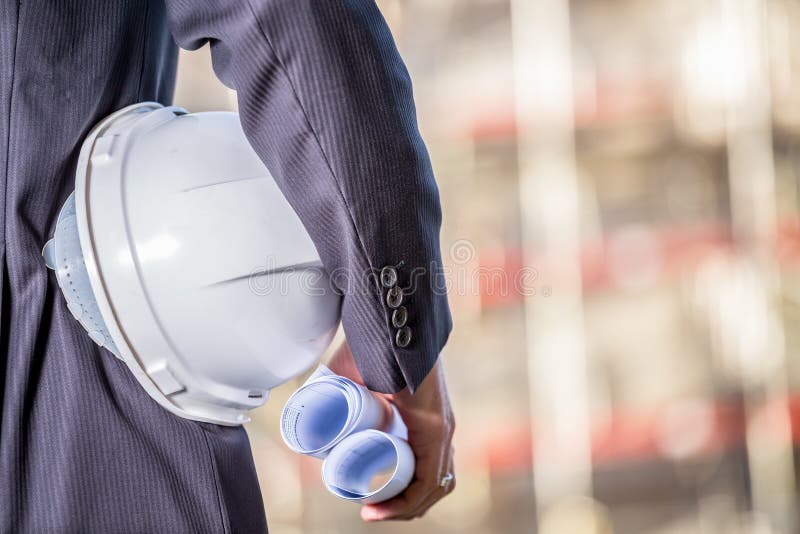 White Helmet and Blueprints on Construction Site Stock Image - Image of ...