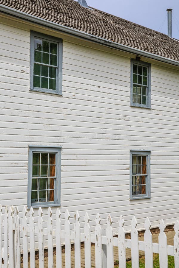A White House with a White Picket Fence in Front of it Stock Photo ...