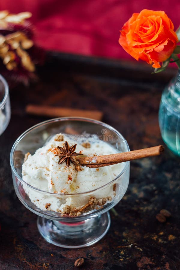 White Ice Cream with Cinnamon and Star Anise on Black Rustic Board ...