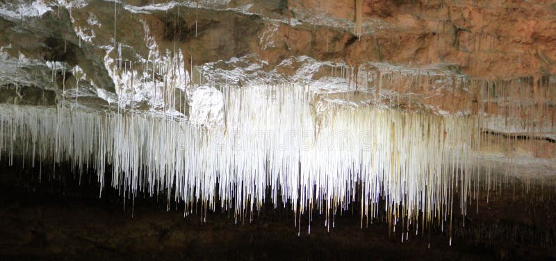 The White Icicles are All Long, Flowing Down a Cave Stock Image - Image ...