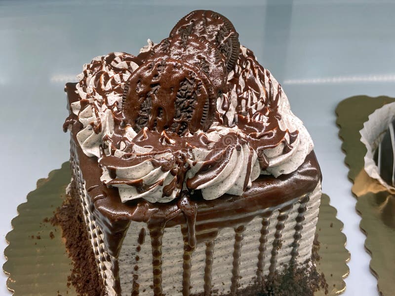 White Icing and Chocolate Drizzle Cake Topped with Cookies Stock Image ...