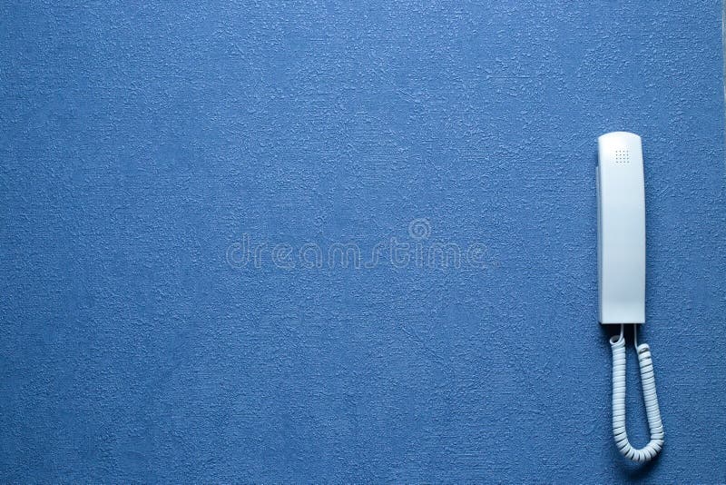 White Intercom Receiver on Blue Wall with Copy Space Stock Image ...
