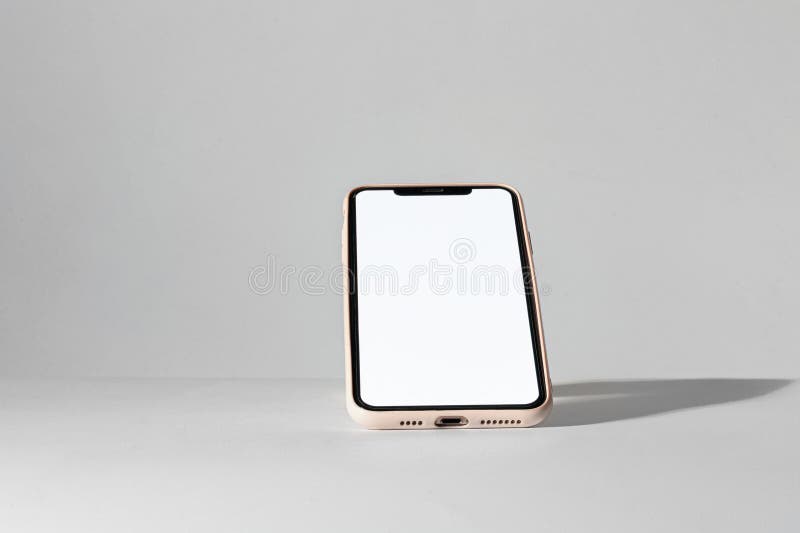 A White IPhone is Sitting on a Table with a White Background Stock ...