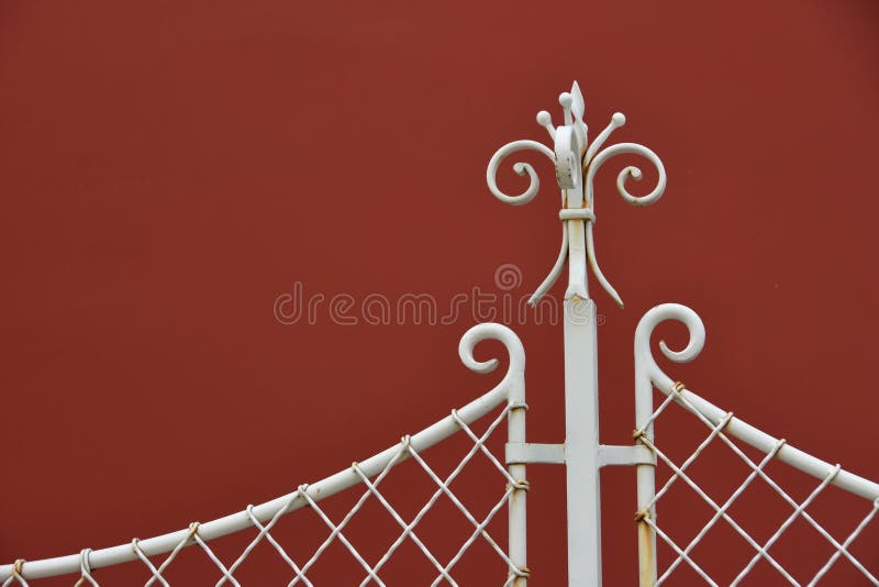 White Iron Fence Details with Red Wall Background Stock Image - Image ...