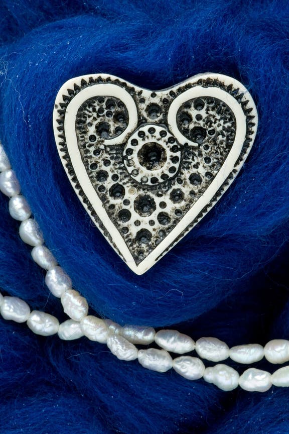 White Ivory Heart Shape on Blue Woolen Textile Stock Image - Image of ...