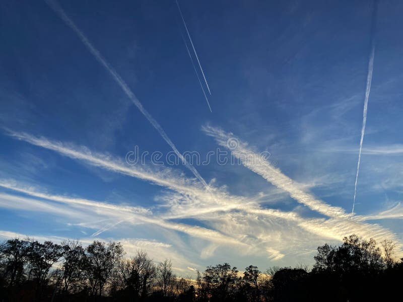 White Jet Contrails and Blue Sky at Sunset Stock Image - Image of white ...