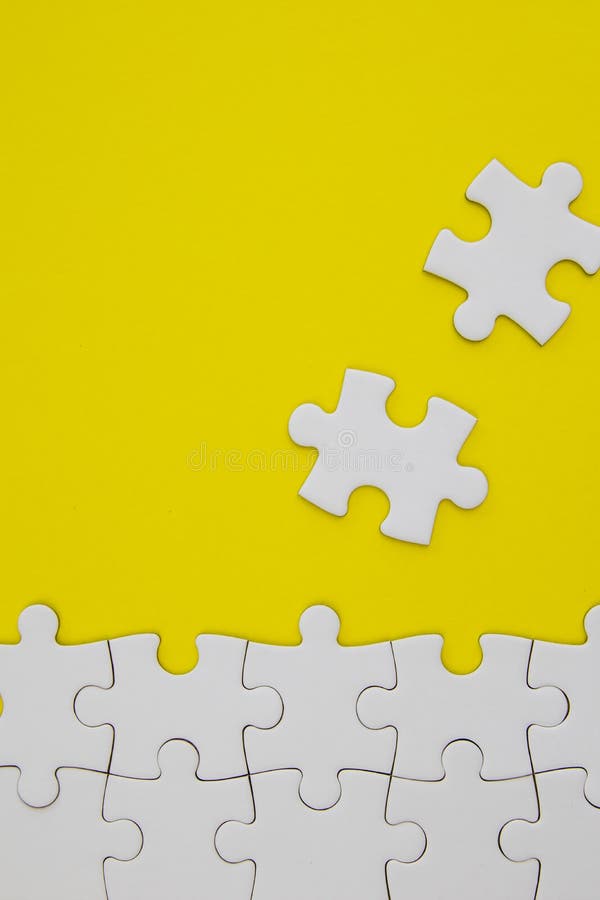 White Jigsaw Puzzle Pieces on Yellow Background with Negative Space ...