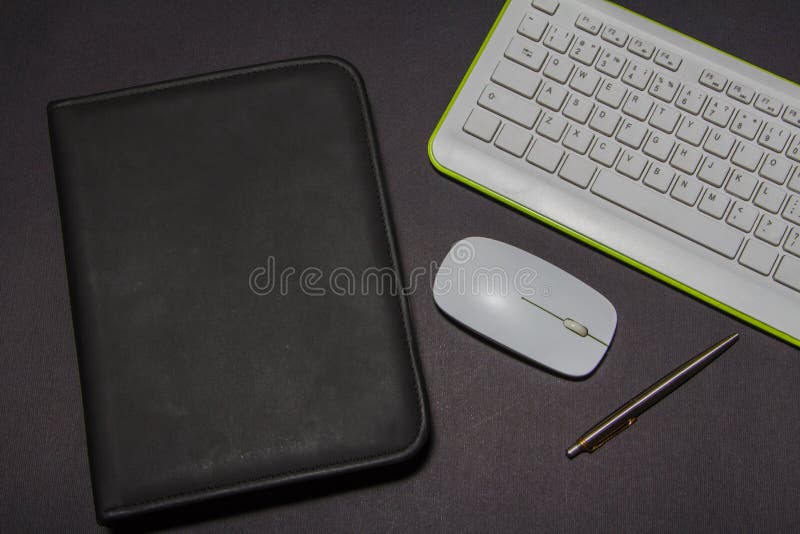 White Keyboard on a Black Background with Leather Folder and Pen. View ...