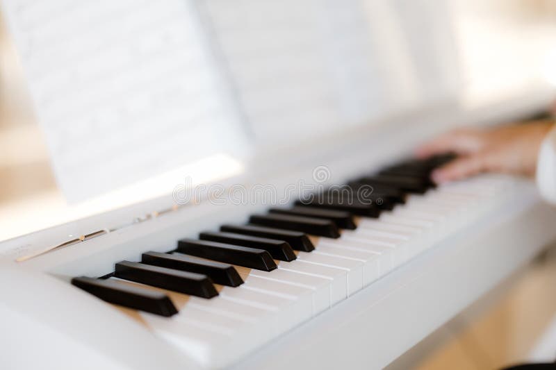 White Keyboard with Sheet Music Stock Photo - Image of closeup ...