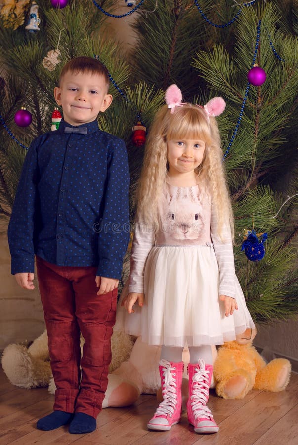 White Kids Posing in Front a Huge Christmas Tree Stock Image - Image of ...