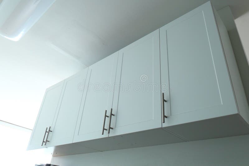 White Wall Mounted Kitchen Cabinets and Kitchen Appliances Stock Photo ...