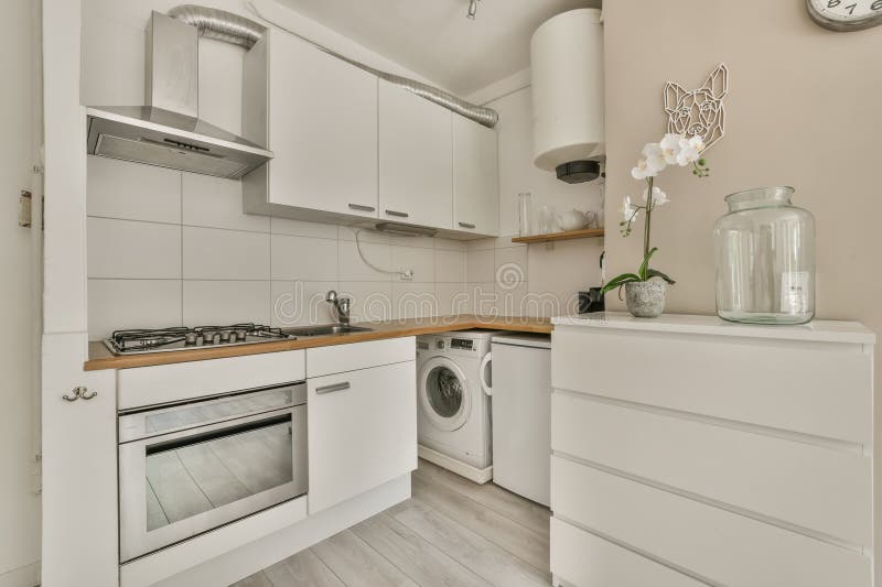A White Kitchen with a Washing Machine and a Sink Stock Photo - Image ...