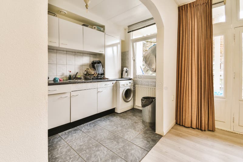 A White Kitchen with a Washing Machine and a Window Stock Image - Image ...